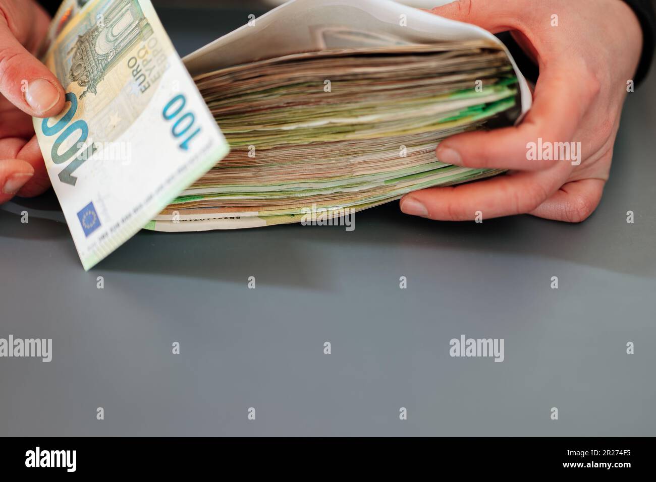 Envelope with money . hand sorting out Euro bills in an envelope on a ...