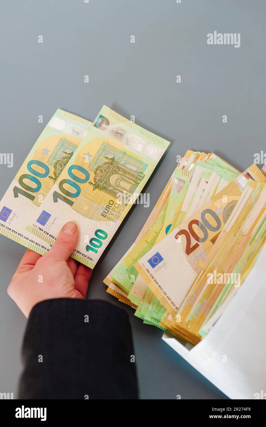 Envelope with money.pack of euro bills in an envelope. Womens hand ...