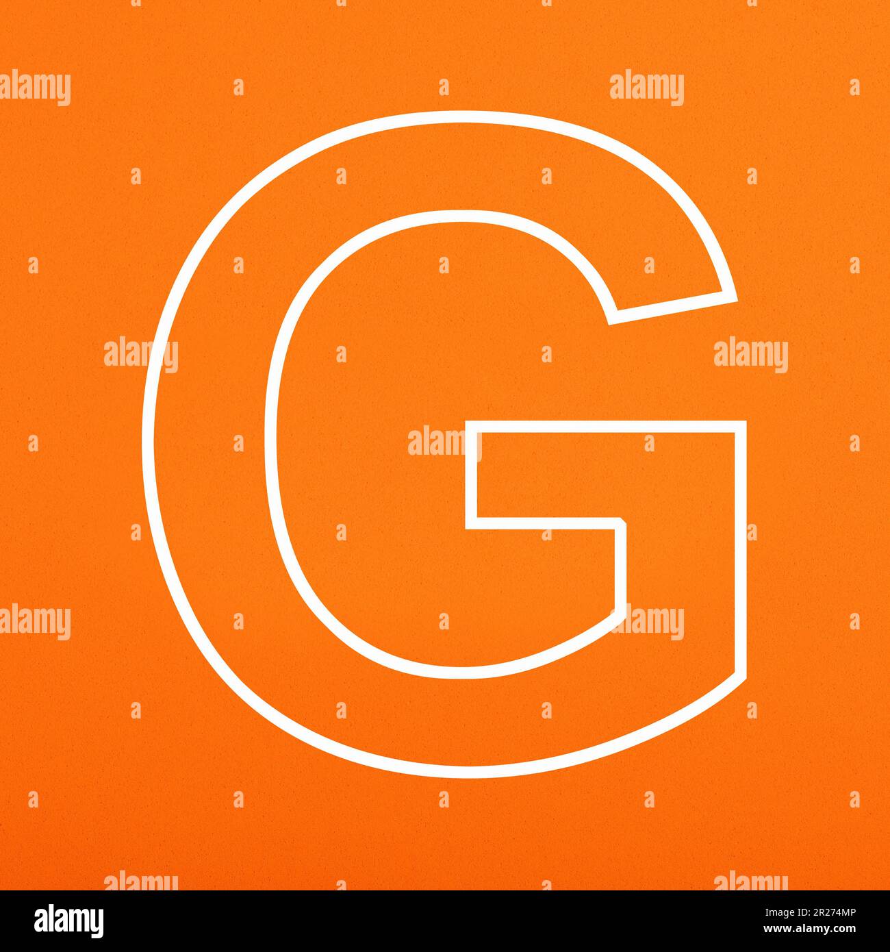 Letter G uppercase written in white color isolated on orange foamy ...