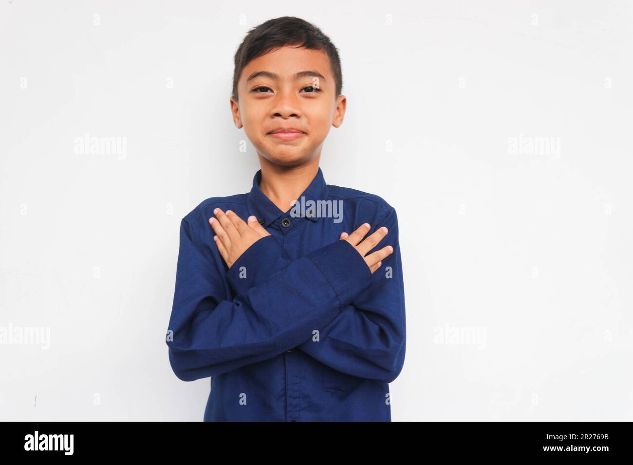 Smiling confidence boy looking at the camera while put his hand on ...