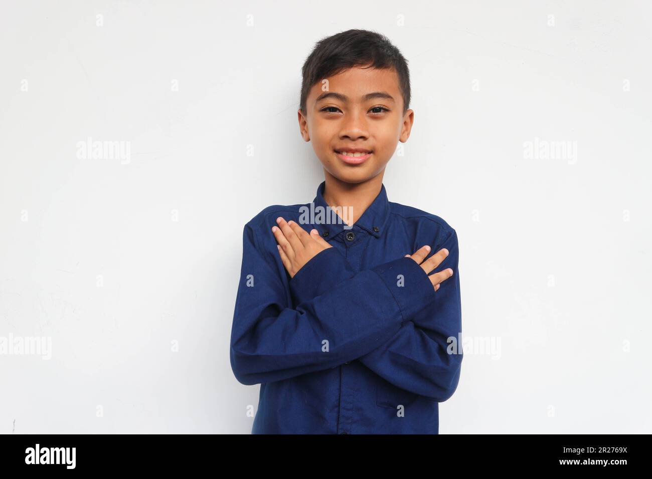 Smiling confidence boy looking at the camera while put his hand on ...