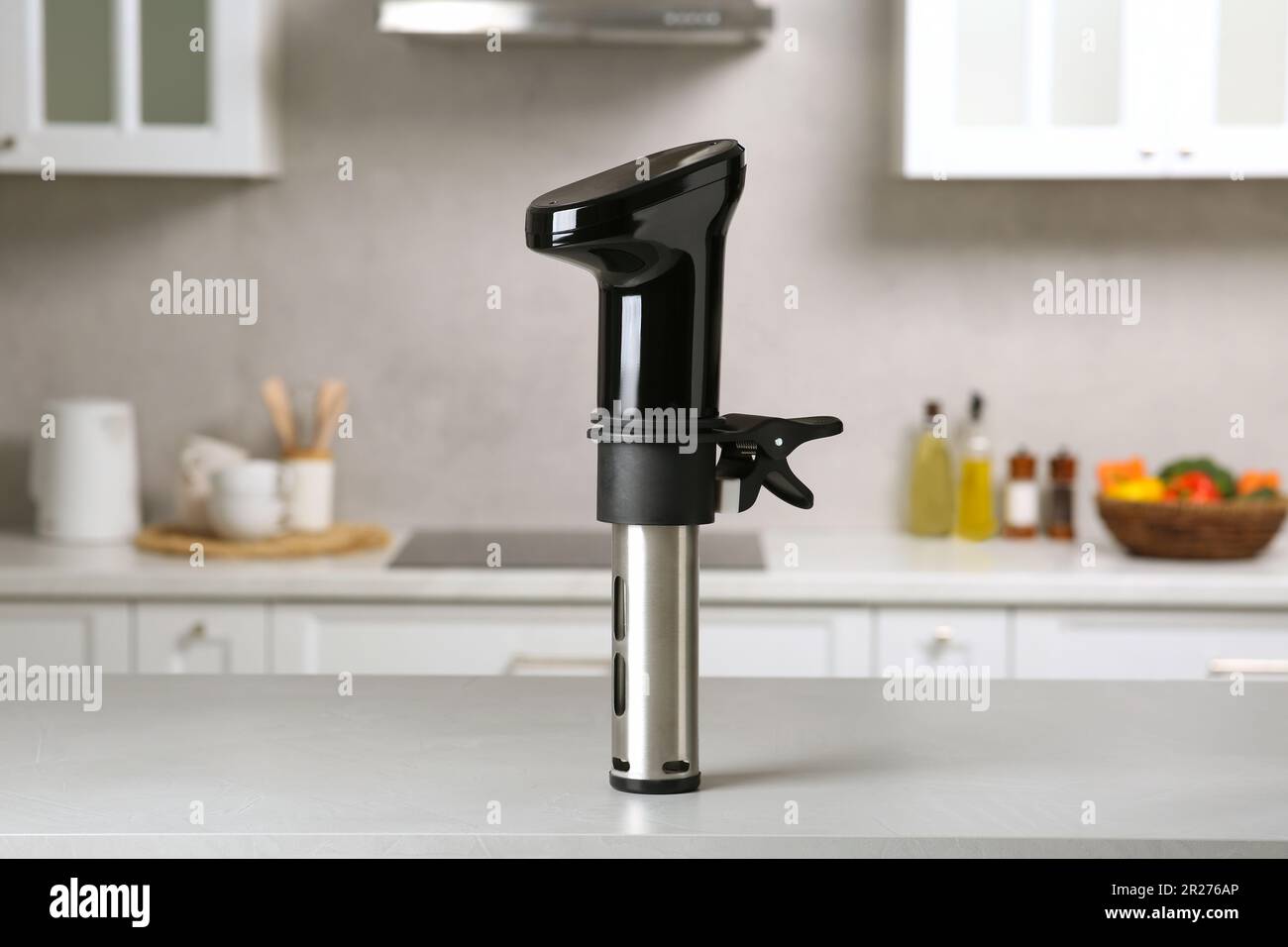 Thermal immersion circulator on white table in kitchen. Sous vide ...