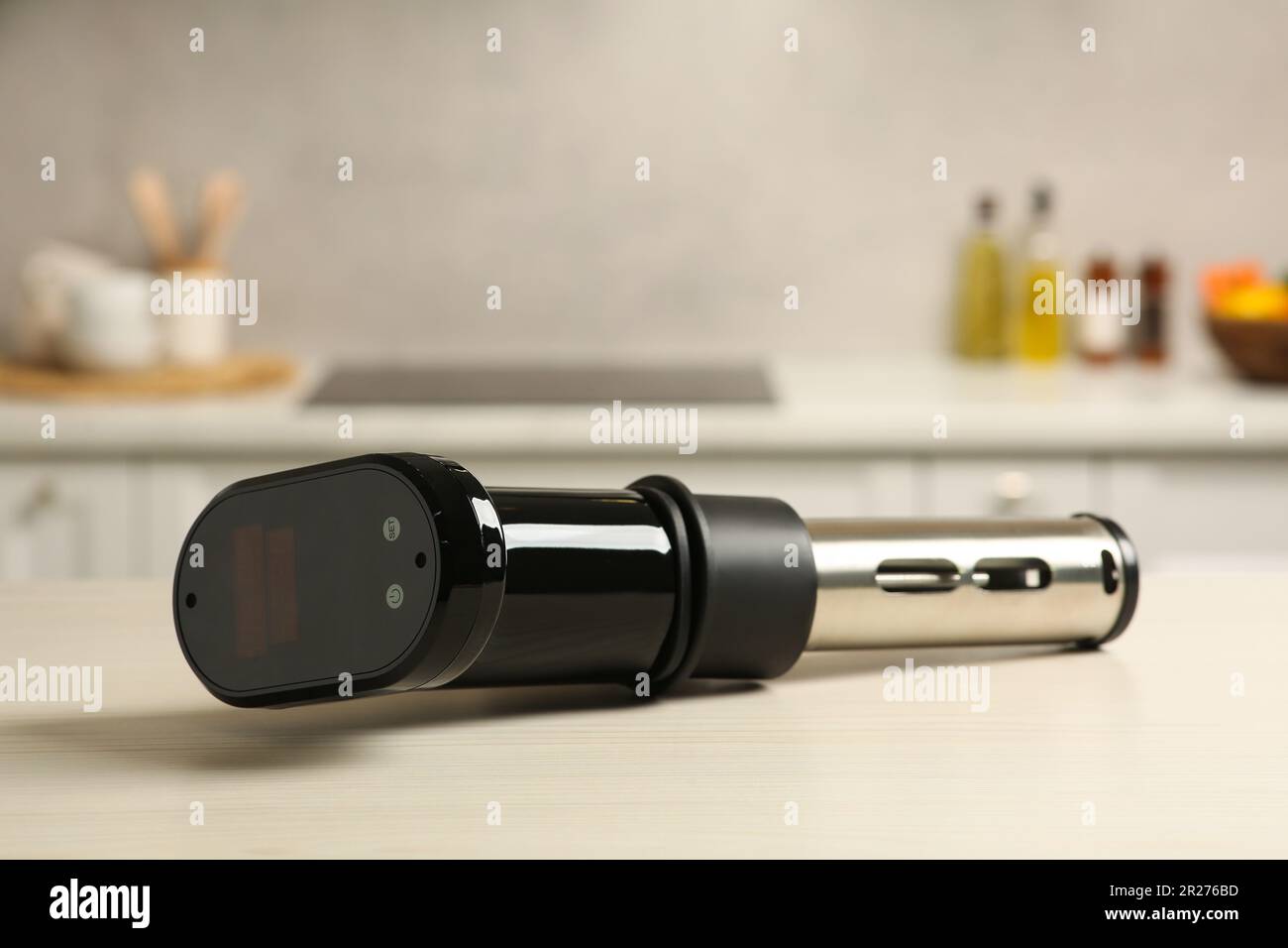 Thermal immersion circulator on white table in kitchen. Sous vide ...