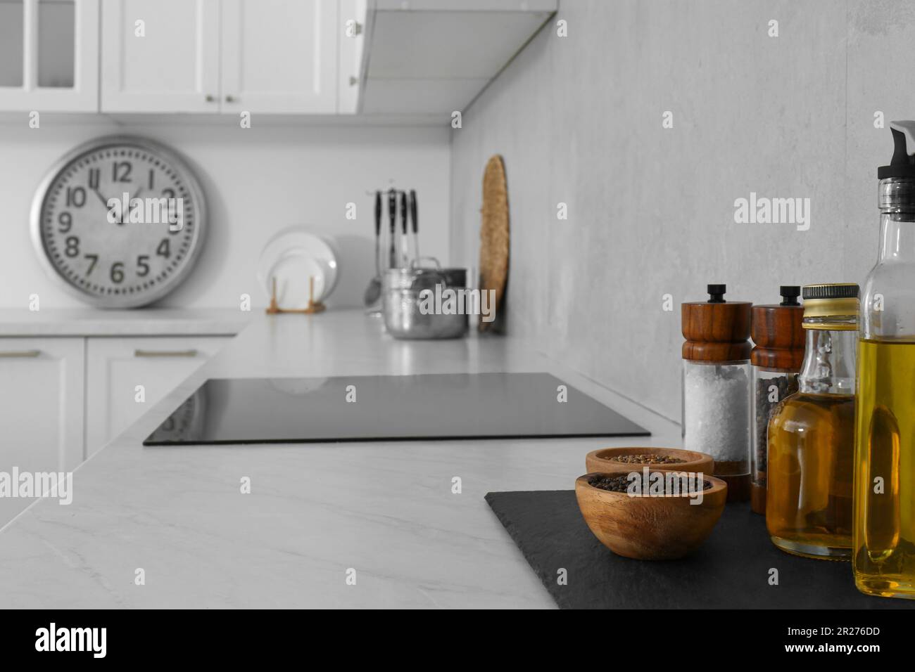 Different ingredients on white marble countertop near cooktop in ...