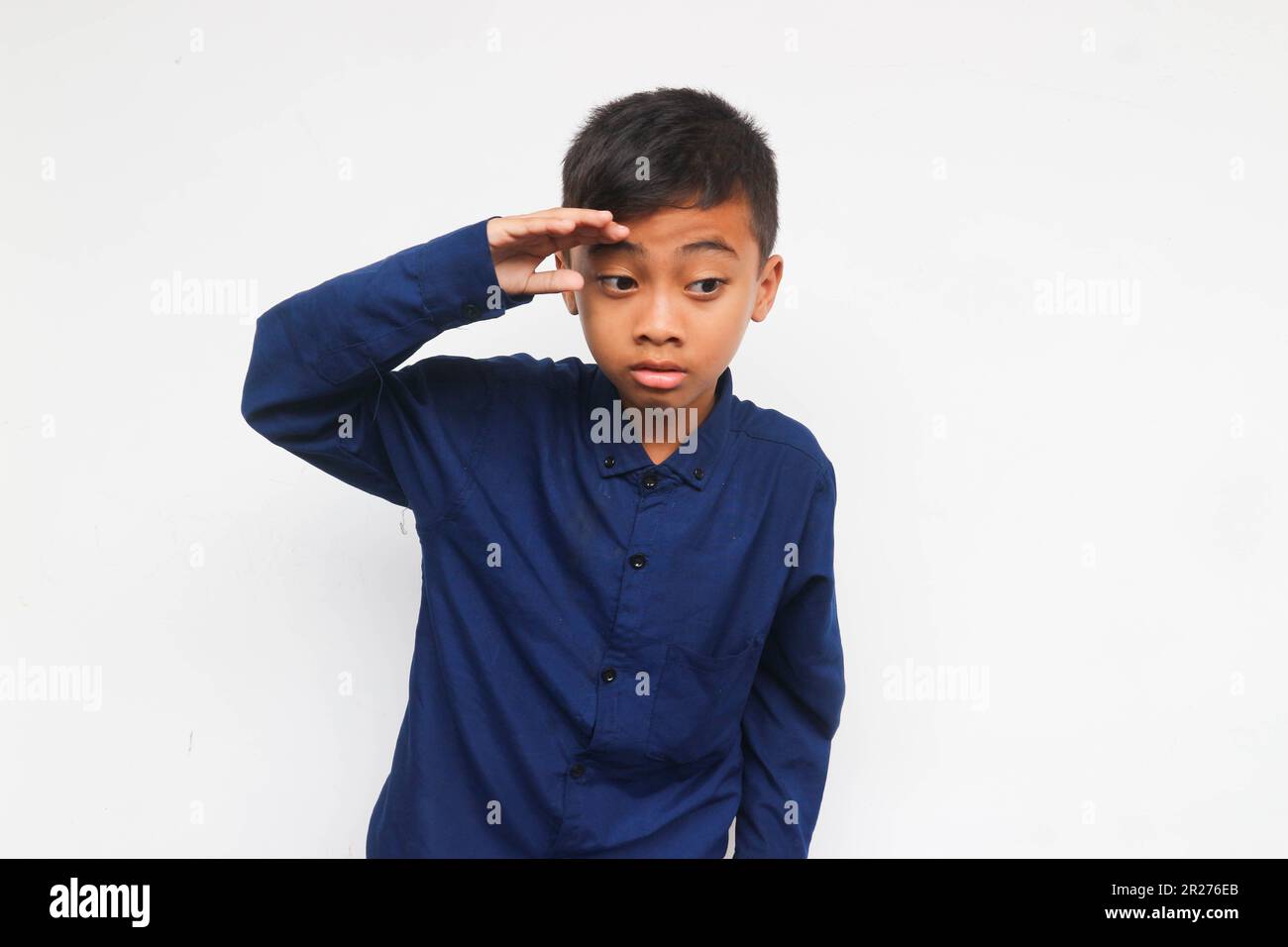 Curious boy looking and find something isolated on the white background ...