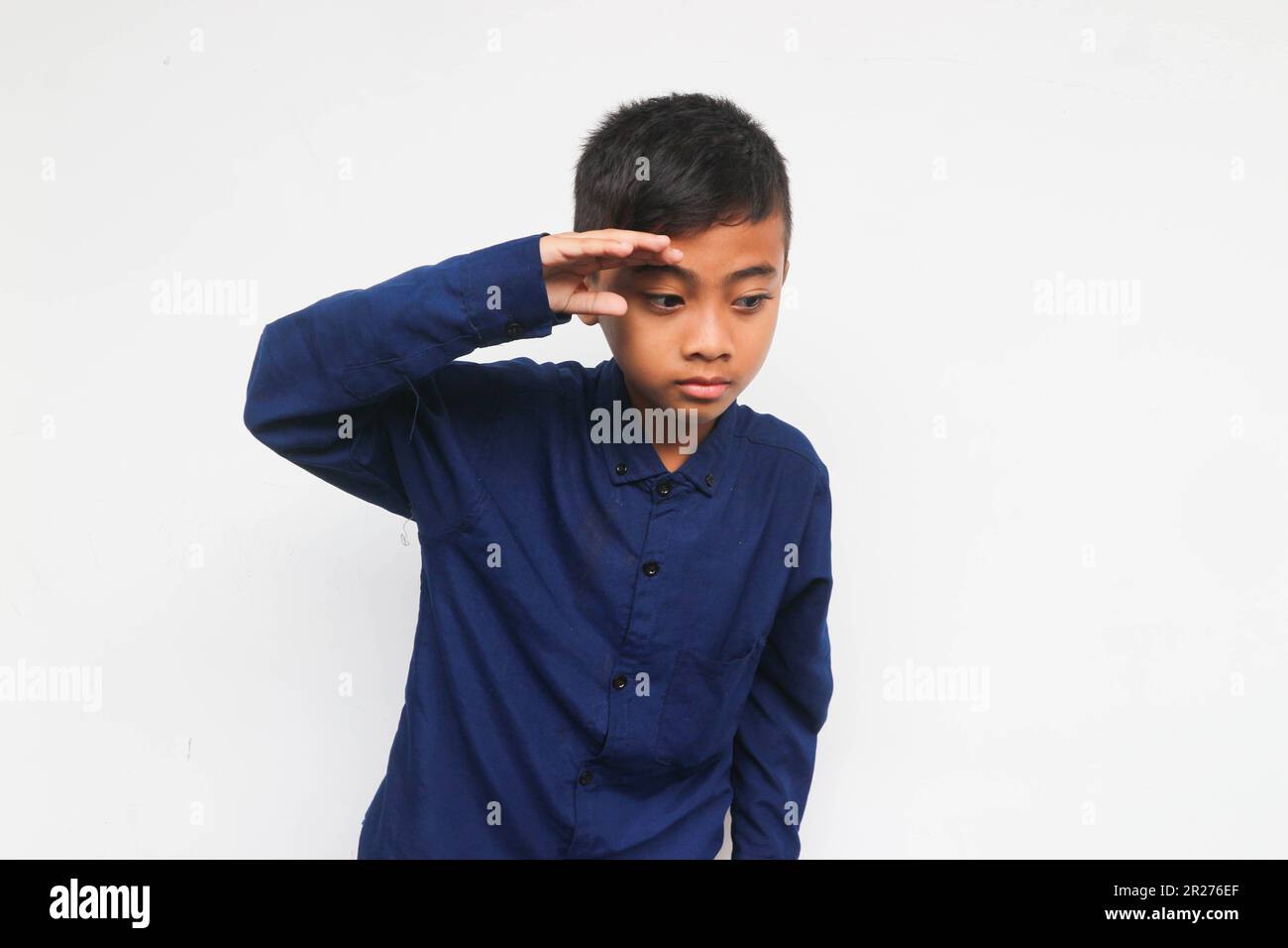 Curious boy looking and find something isolated on the white background ...