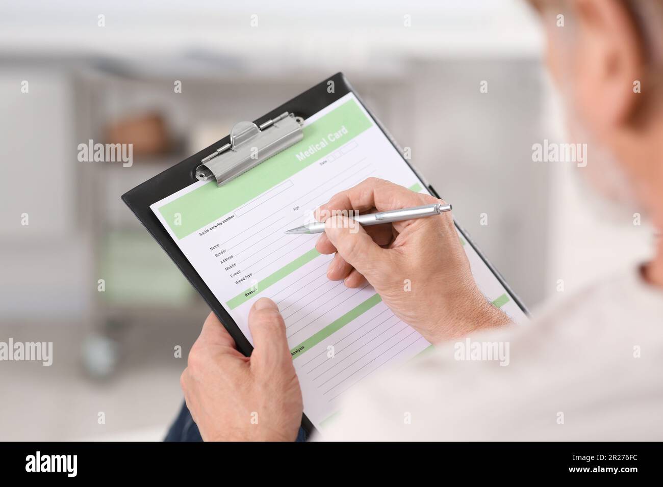 Patient filling his medical card in clinic, closeup Stock Photo - Alamy