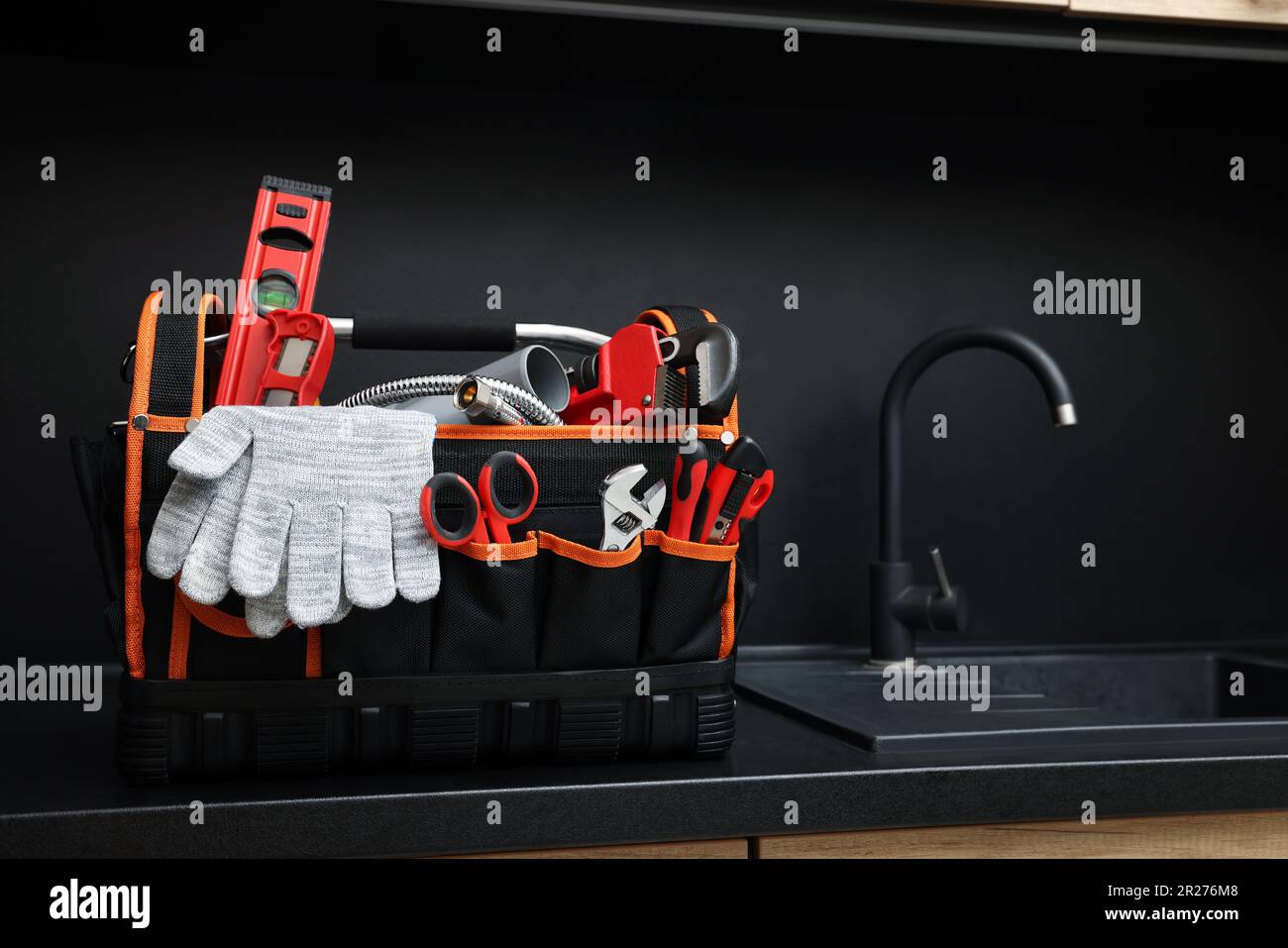 Plumber's tool bag on kitchen counter near sink Stock Photo - Alamy