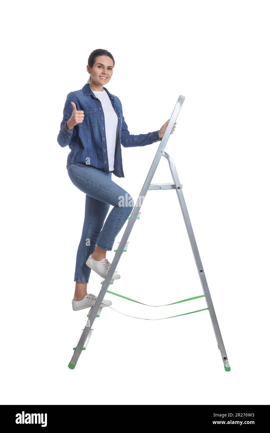 Young woman climbing up metal ladder on white background Stock Photo ...