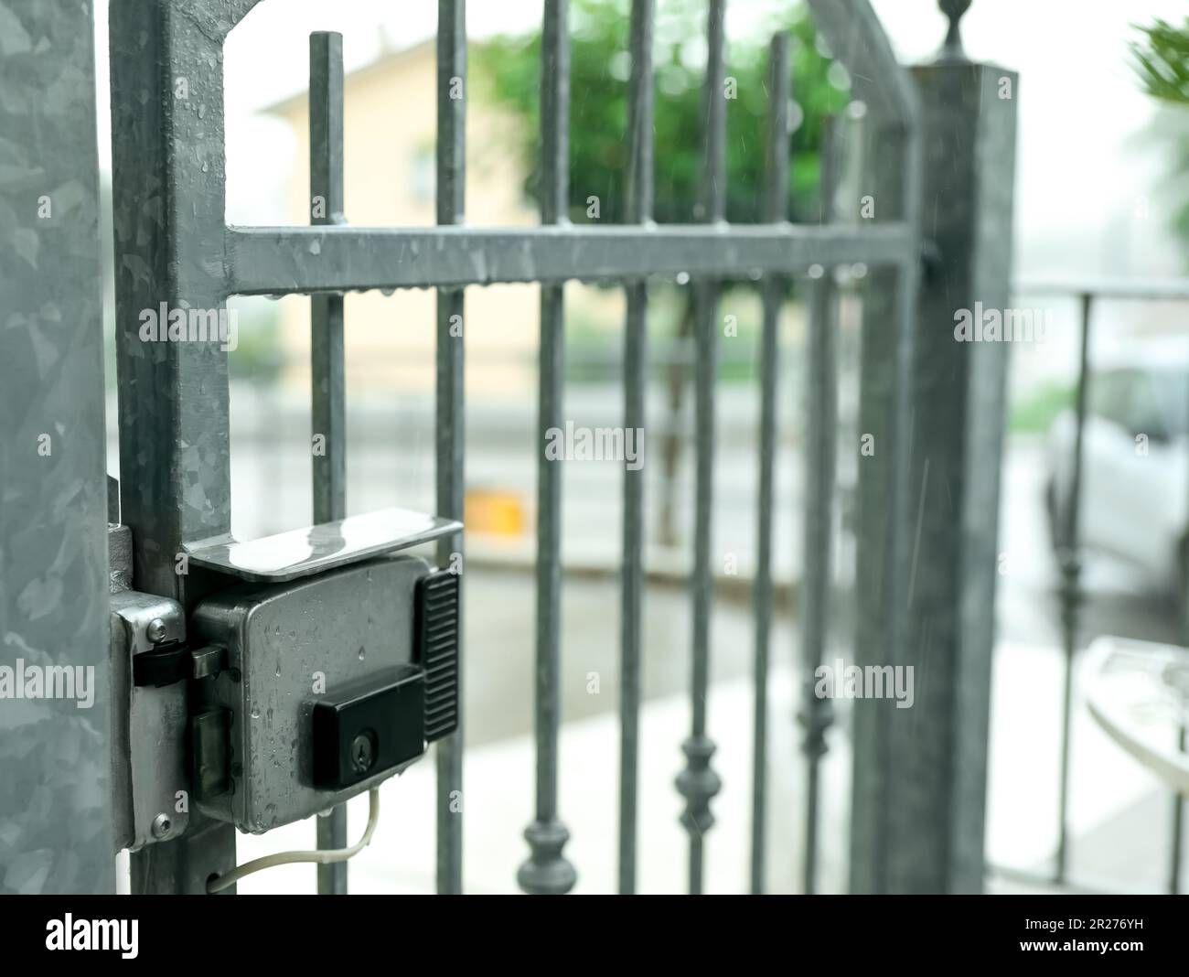 Stainless electromechanical lock on gate outdoors under rain Stock ...