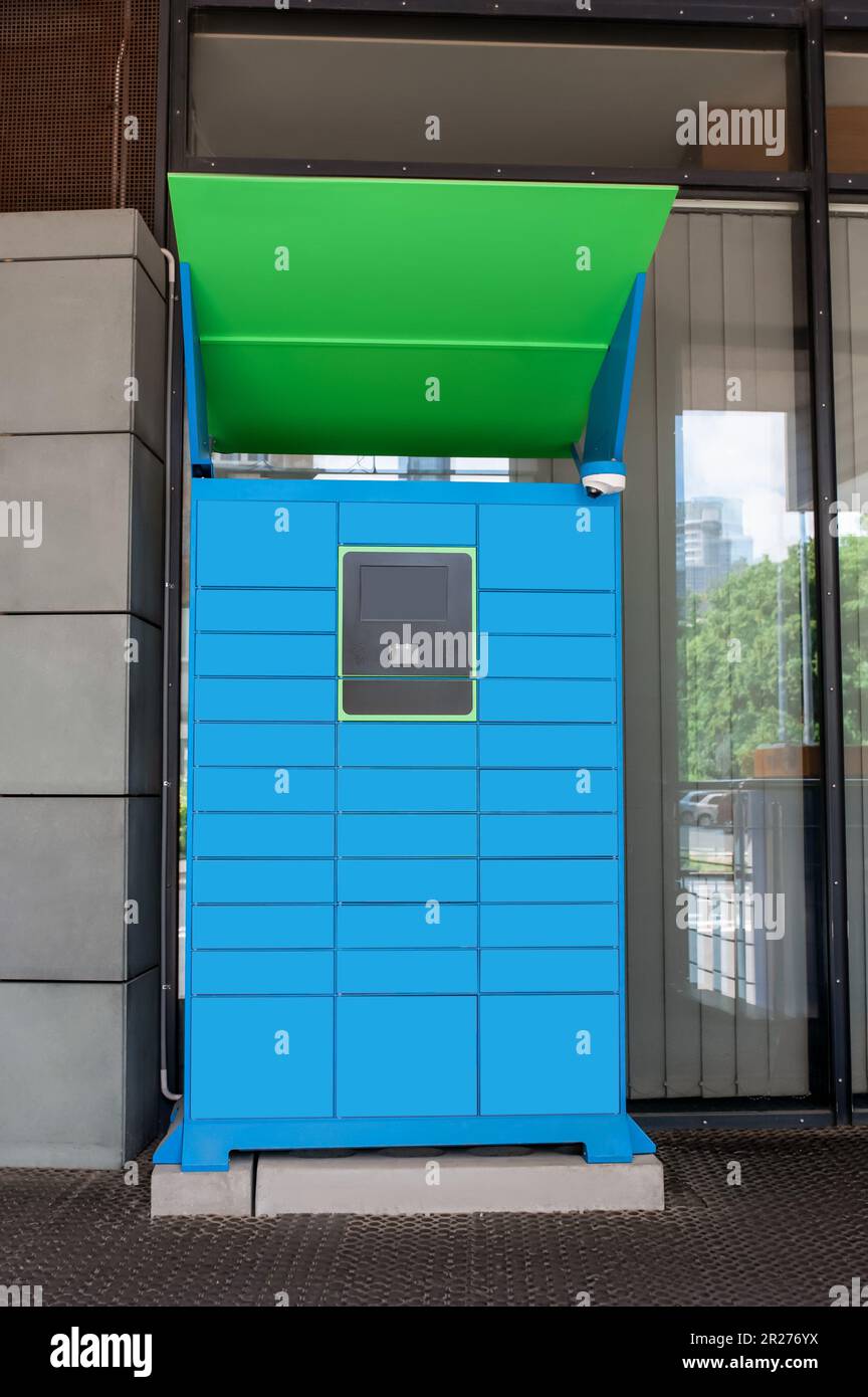 Parcel locker with many postal boxes near building outdoors Stock Photo ...
