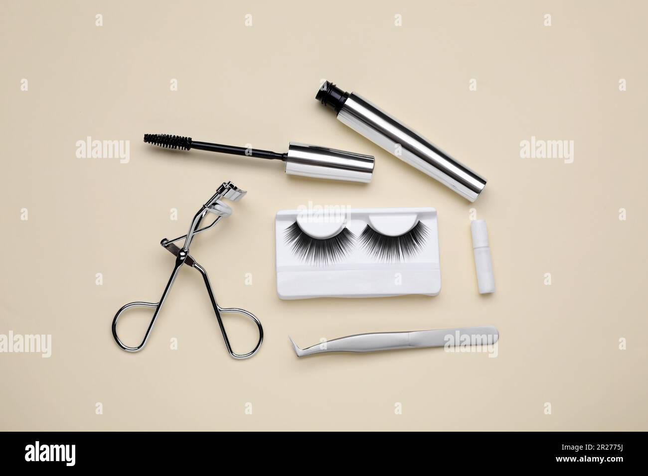Flat lay composition with fake eyelashes on beige background Stock ...