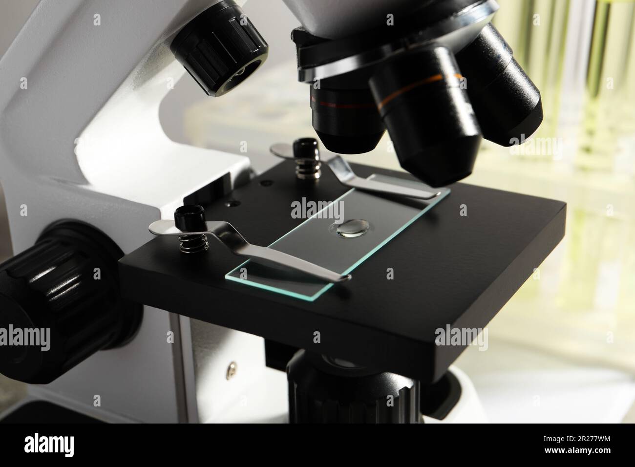 Microscope with drop of urine on glass slide in laboratory, closeup ...