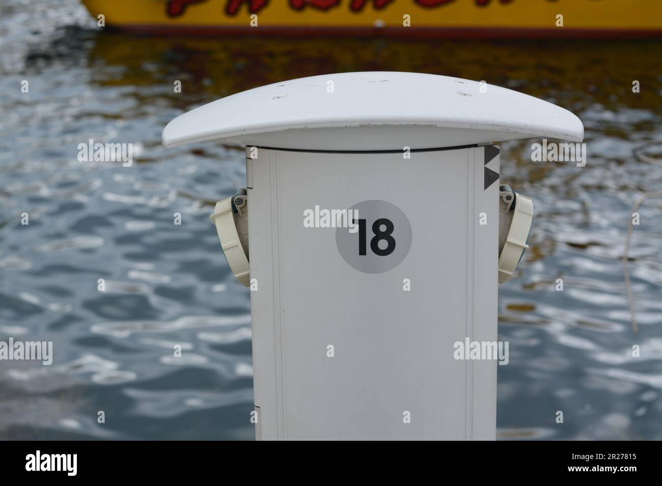 Charging station for boats with electrical outlets in harbor near sea ...