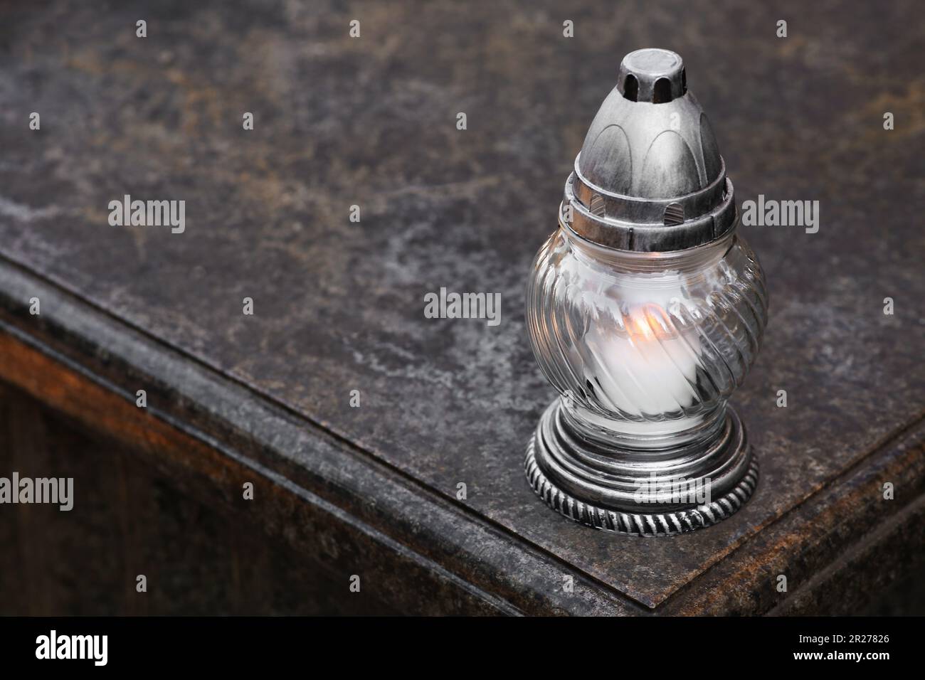 Grave lantern with burning candle on granite surface in cemetery, space for text Stock Photo - Alamy