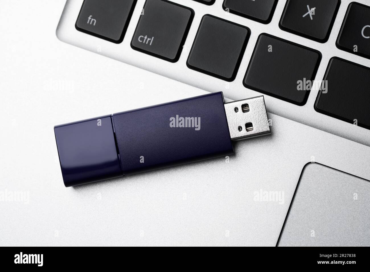 Modern usb flash drive on laptop, top view Stock Photo - Alamy