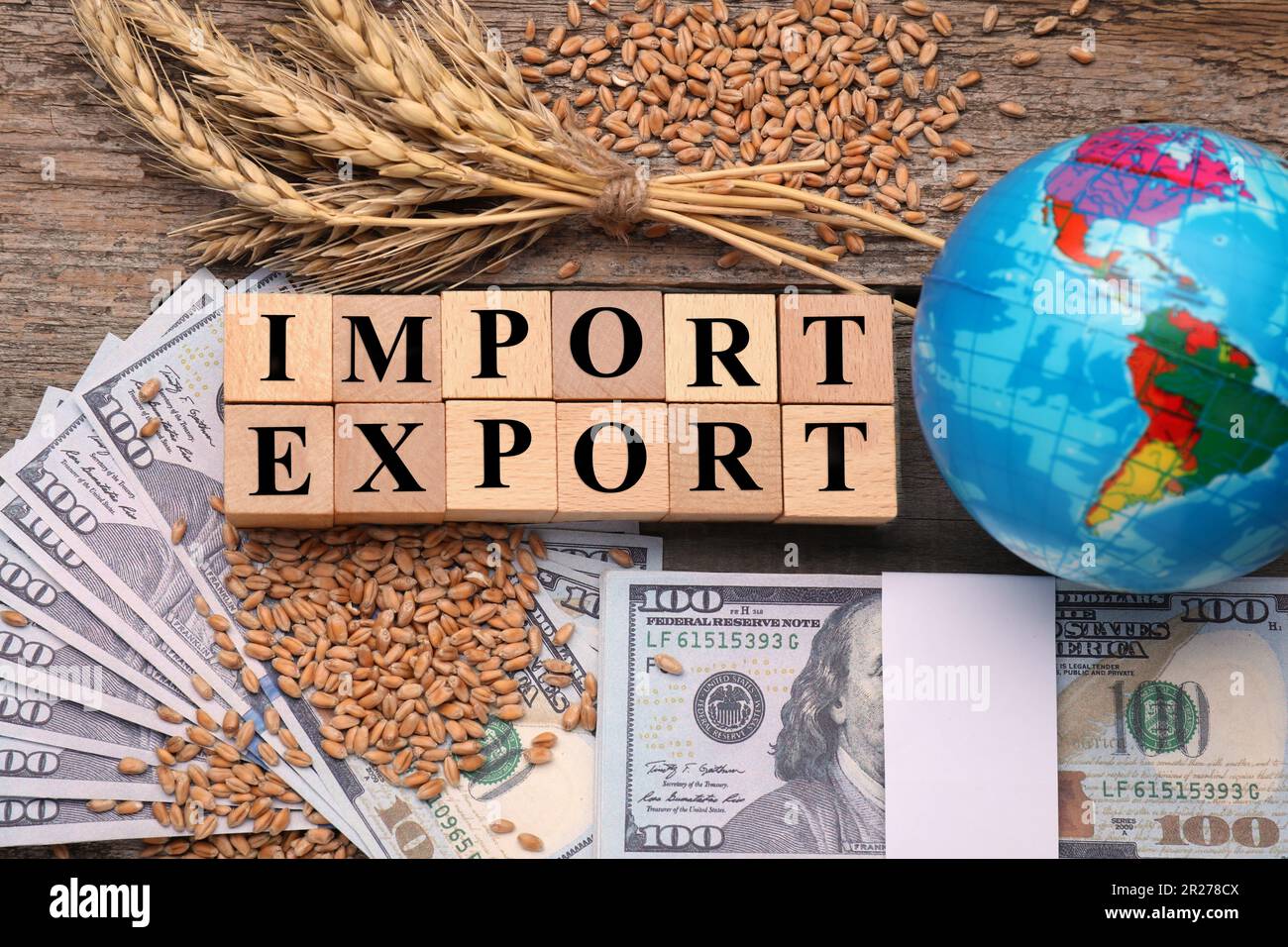 Words Import and Export made of cubes, ears of wheat, banknotes and ...