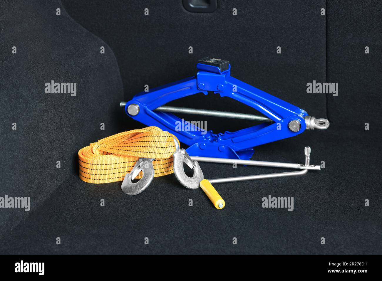 Scissor jack and towing strap in trunk. Car safety equipment Stock ...