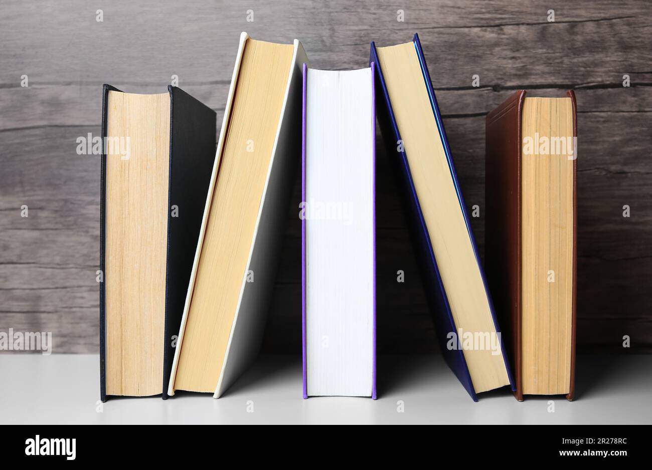 Collection of different books on white shelf Stock Photo - Alamy