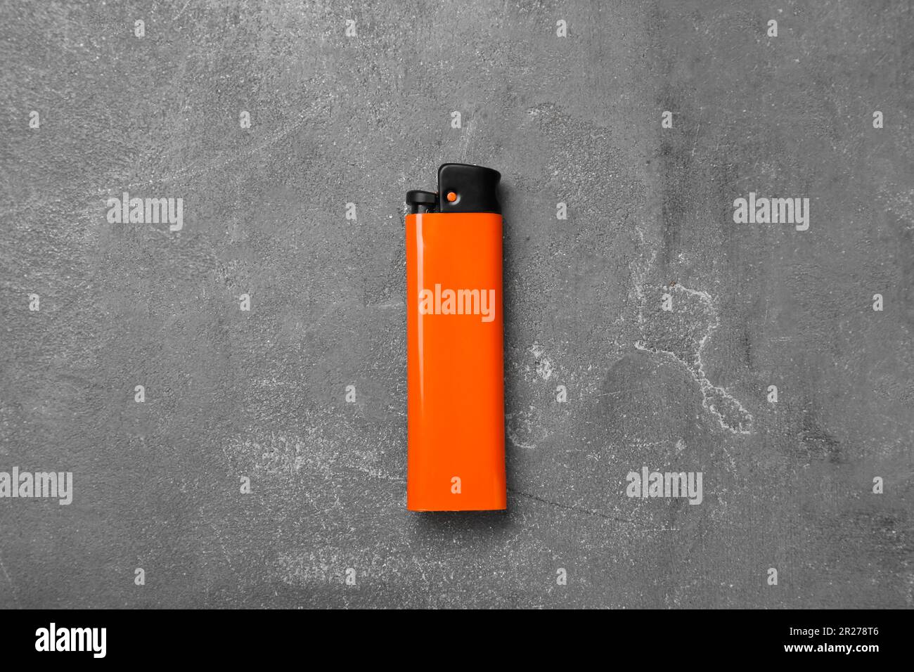 Stylish small pocket lighter on grey table, top view Stock Photo - Alamy