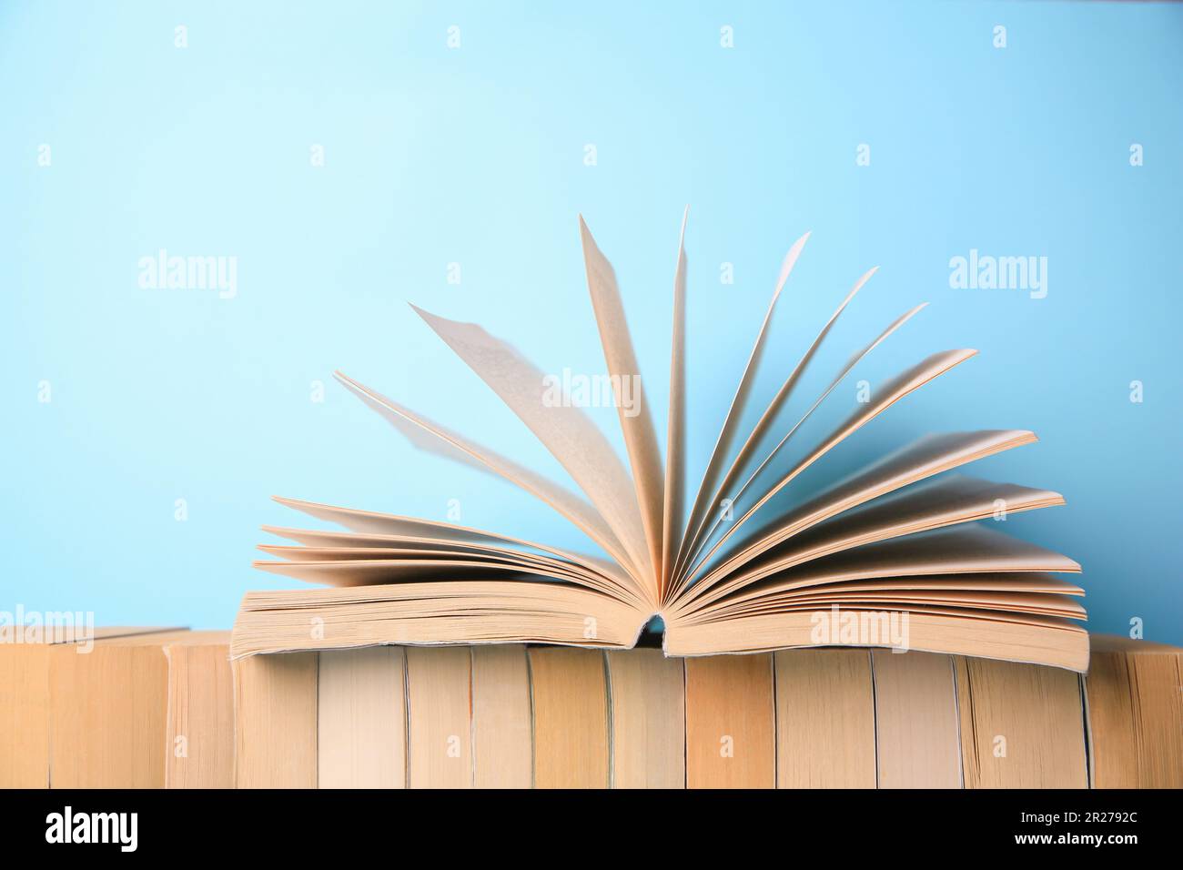 Collection of books on light blue background Stock Photo - Alamy