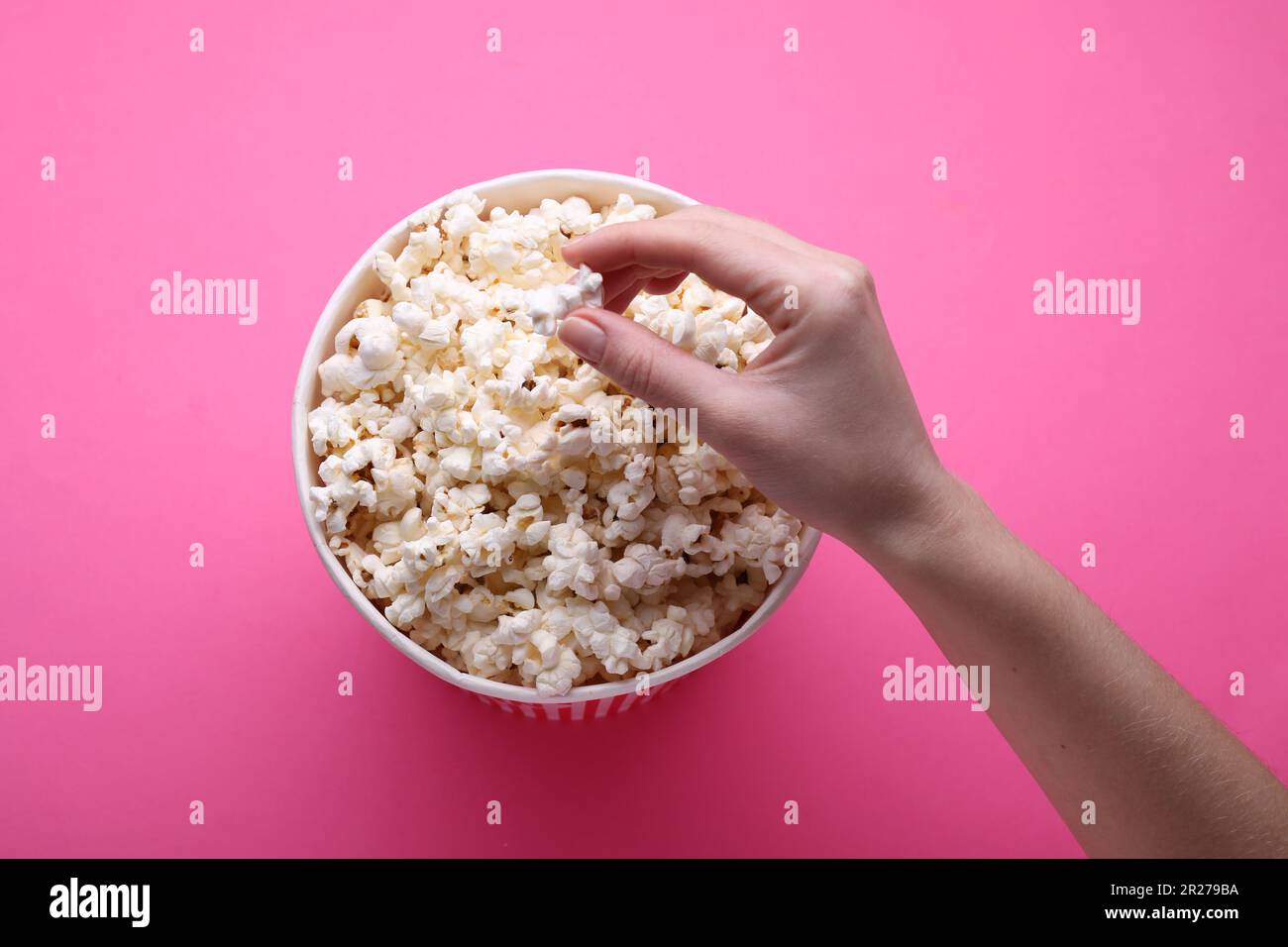 Woman taking delicious popcorn hi-res stock photography and images - Alamy