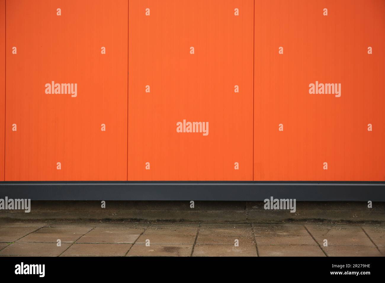 Beautiful orange wall and stone pavement outdoors Stock Photo - Alamy
