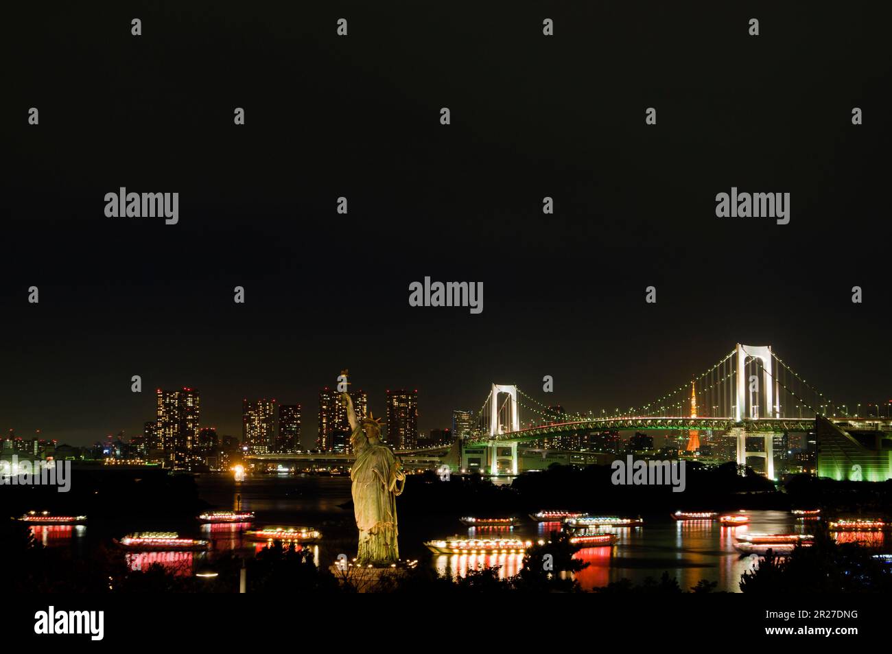 Statue of Odaiba and Rainbow Bridge and houseboat at night Stock Photo ...
