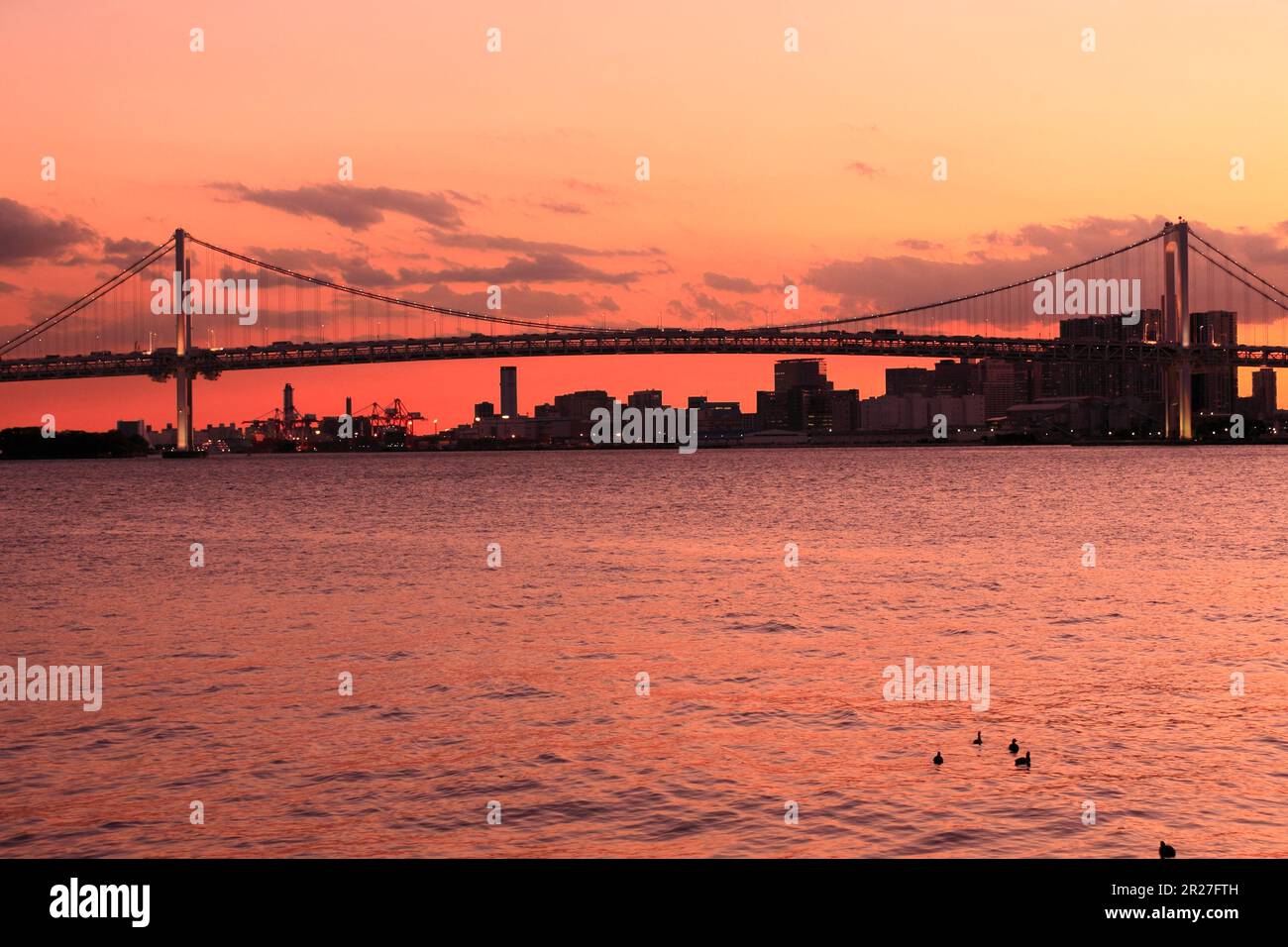 Tokyo Harbor Rainbow Bridge sunset Stock Photo - Alamy