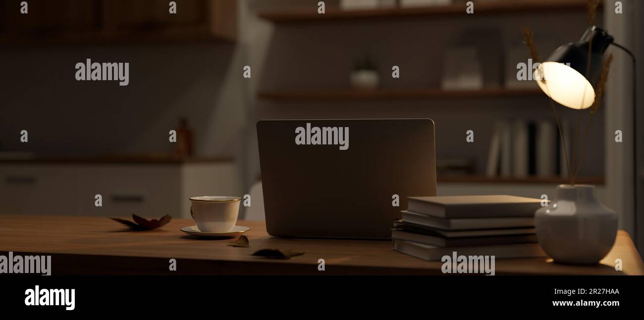 Modern workspace at night in a dark room with laptop computer, table ...