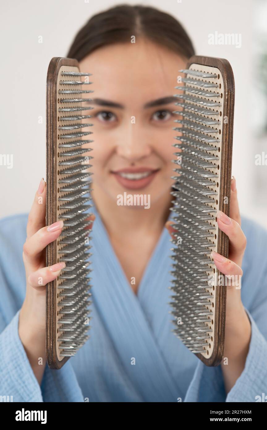 Asian woman holding sadhu boards on face background Stock Photo - Alamy
