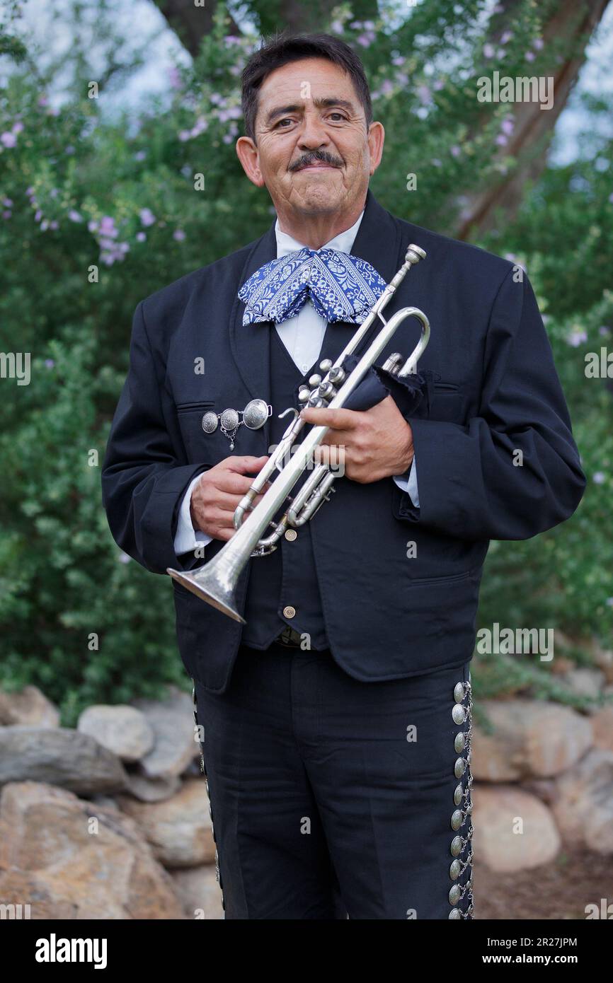 Mariachi musician outside in a garden holding his trumpet, Tucson ...