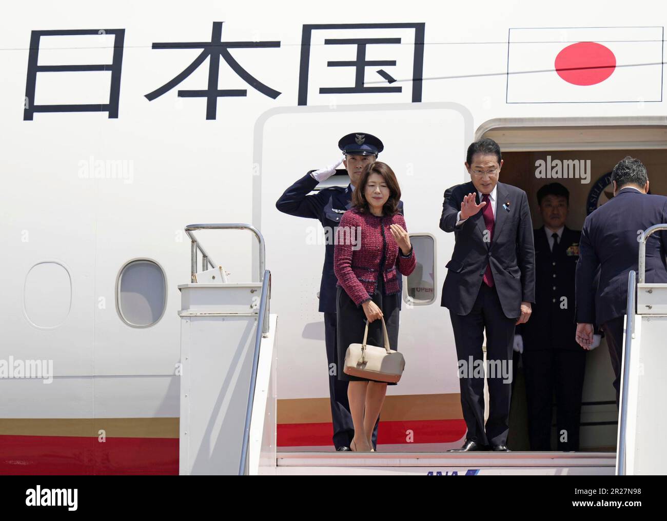 Japanese Prime Minister Fumio Kishida, center, and his wife Yuko wave as they depart for ...