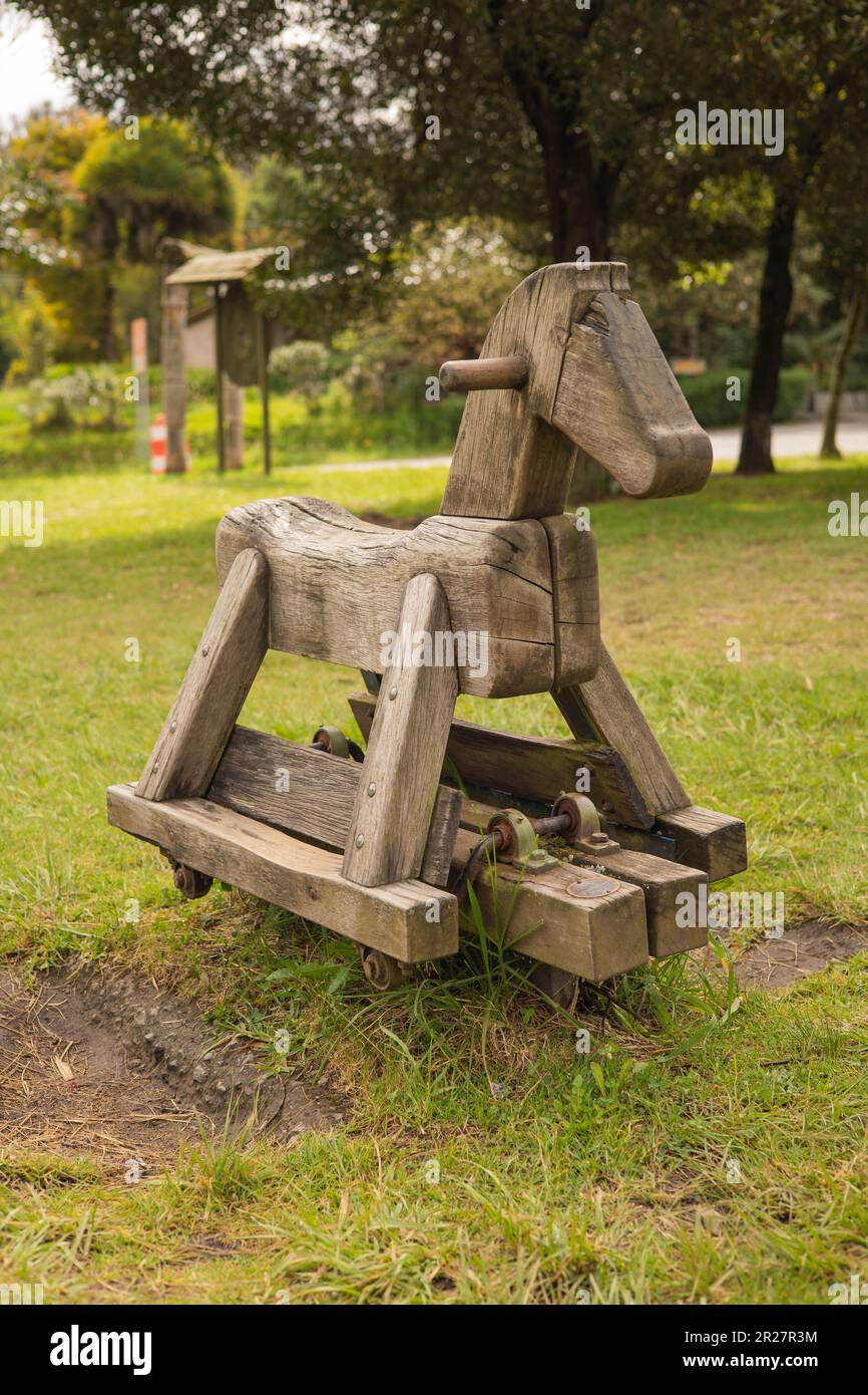 rustic toy in a park, rocking chair in the shape of a wooden horse ...
