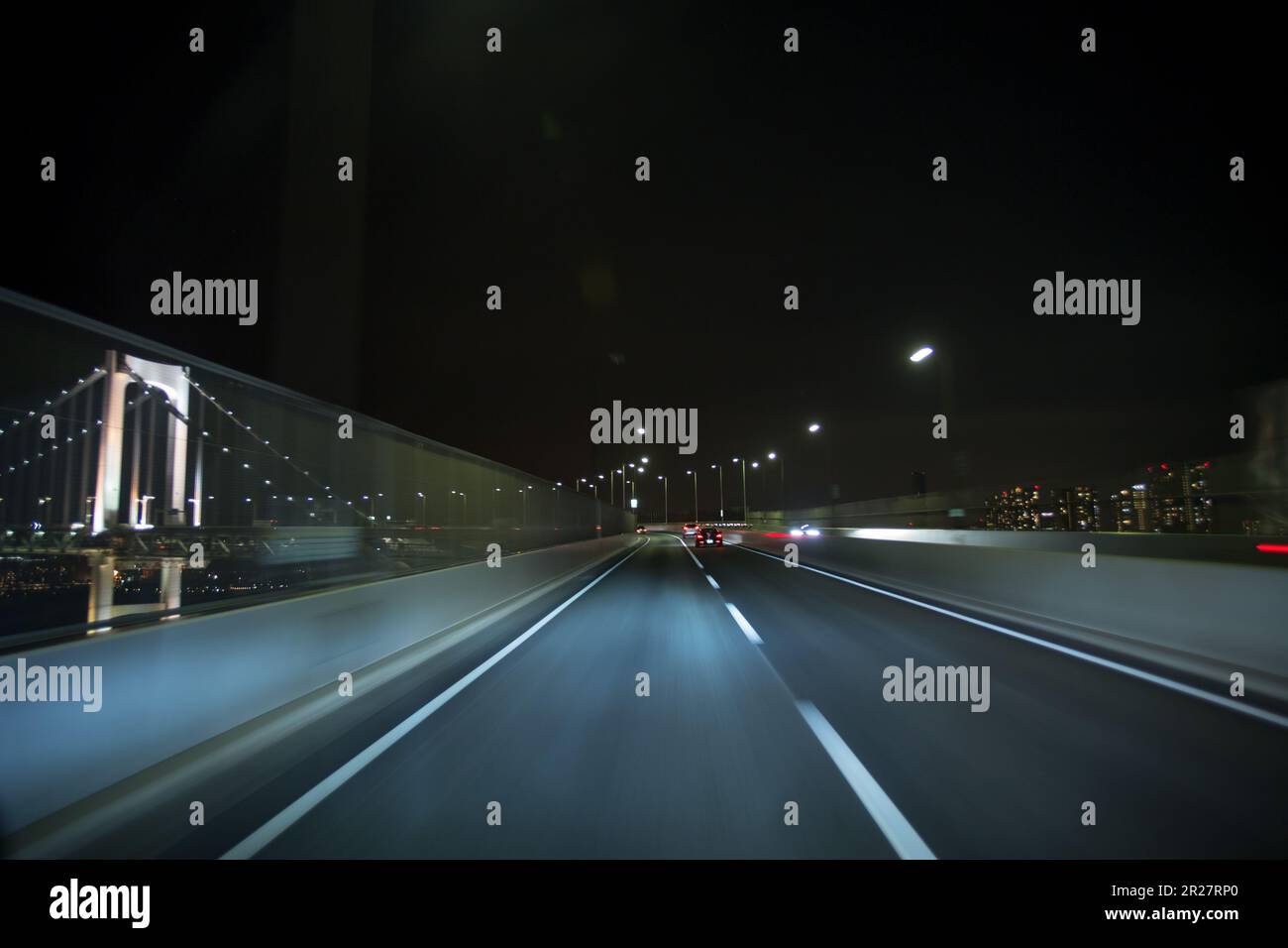 Driving on Rainbow Bridge at night Stock Photo - Alamy