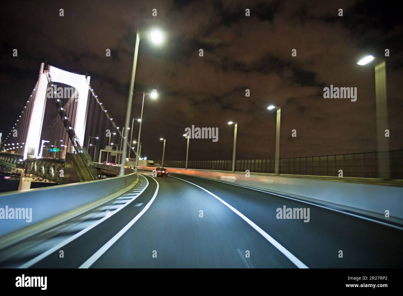 Driving on Rainbow Bridge at night Stock Photo - Alamy