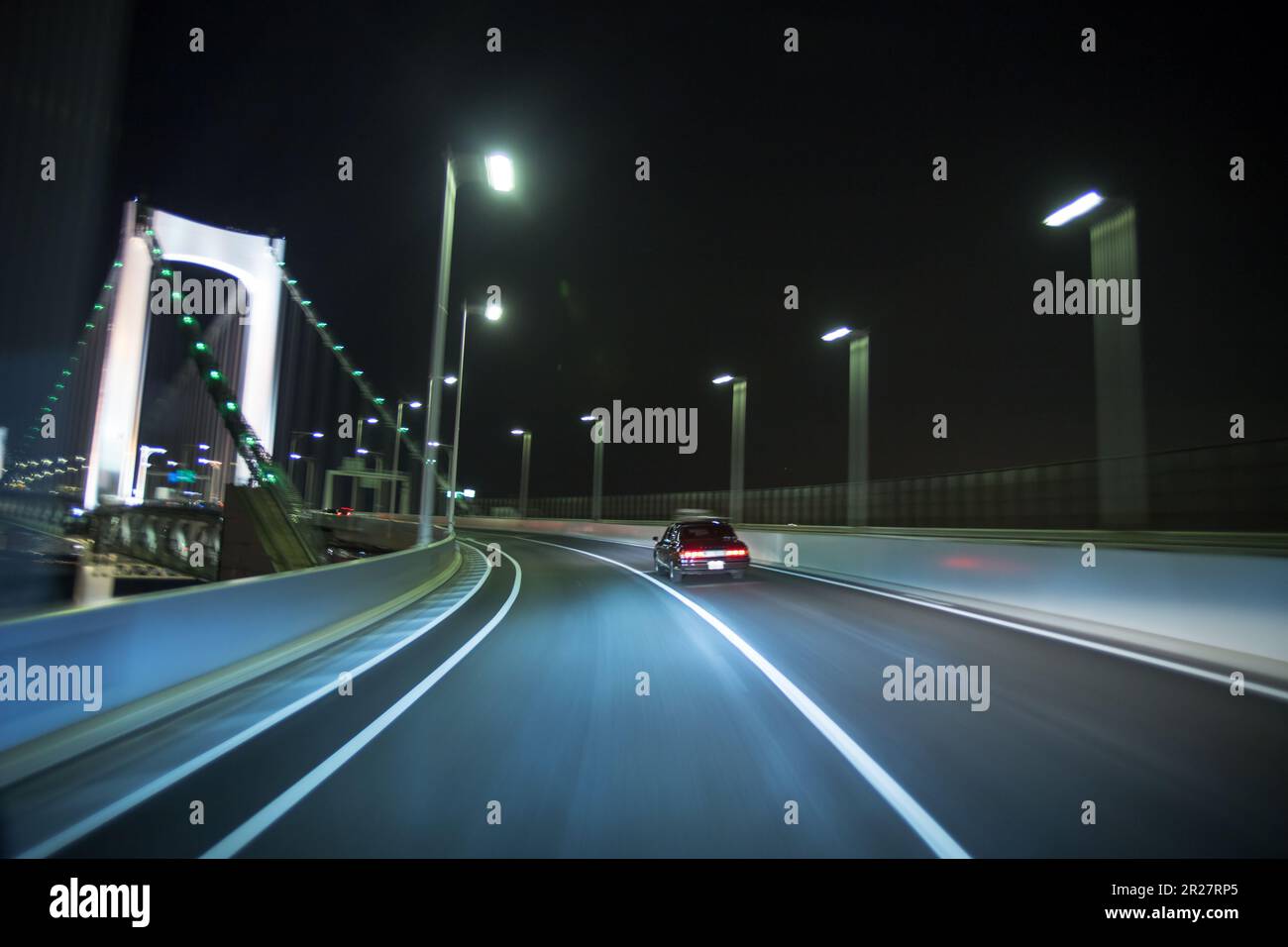 Driving on Rainbow Bridge at night Stock Photo - Alamy