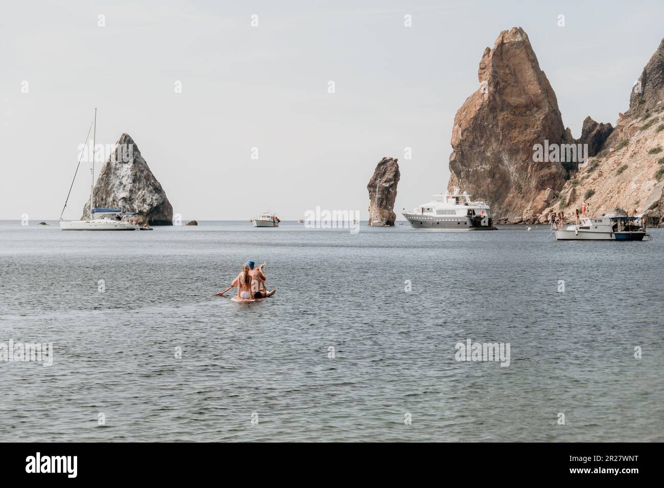 Family sea sup. Young happy father with his son and daughter Floating ...