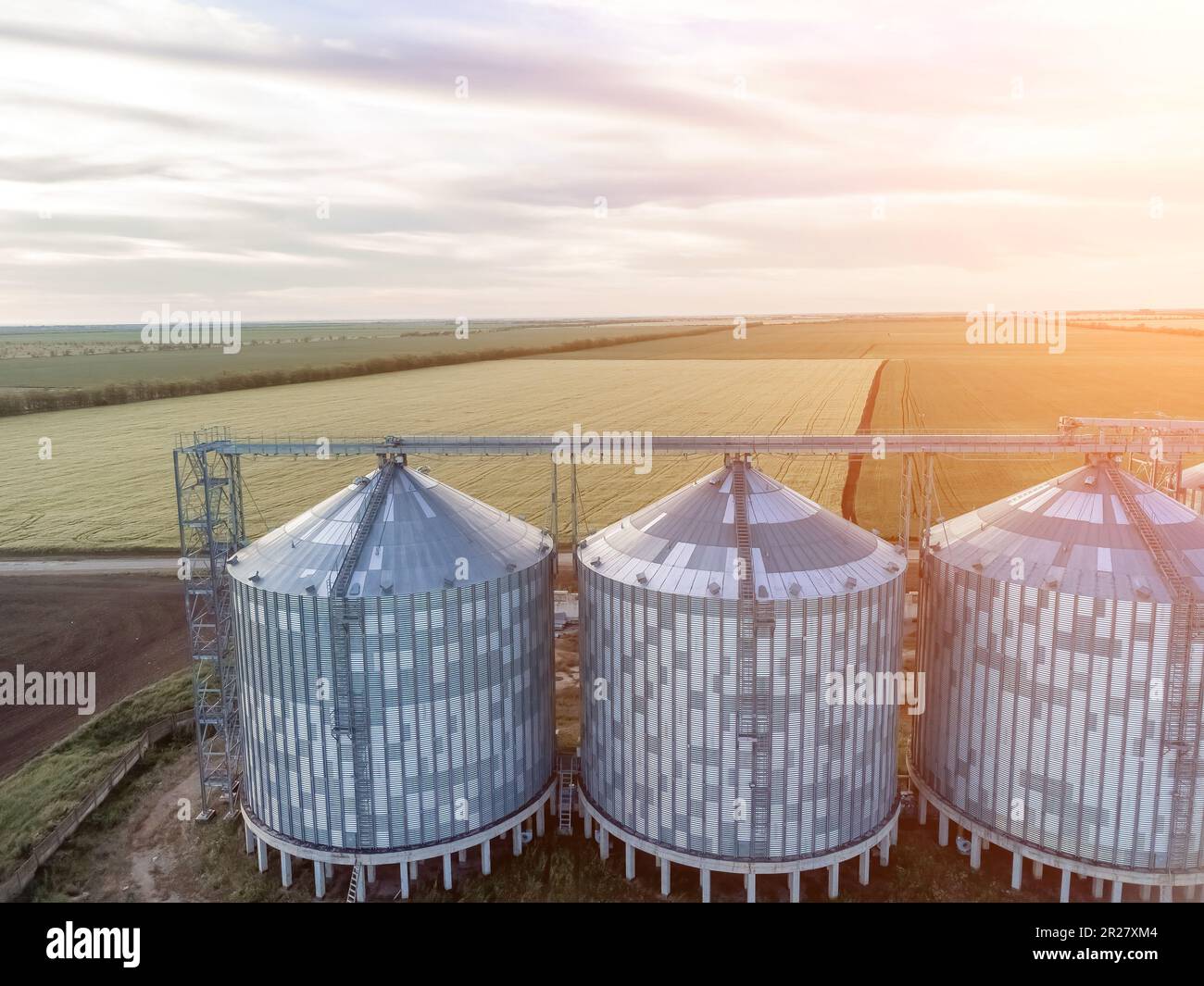 Modern metal silos on agro-processing and manufacturing plant. Aerial ...