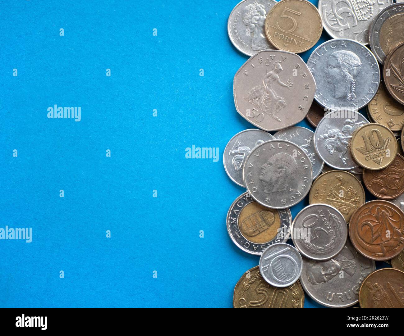 Coins of different countries on the blue background, copy space Stock ...