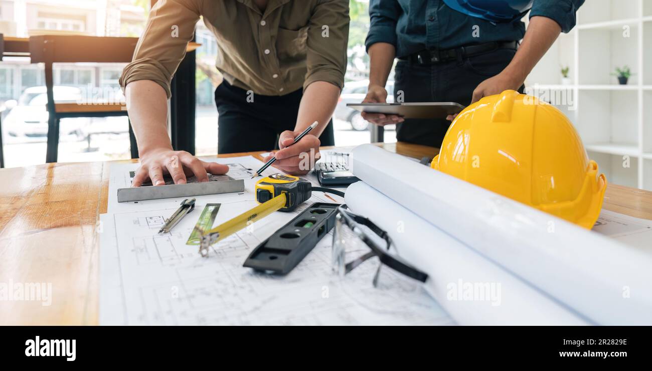engineer working in office with blueprints, inspection in workplace for ...