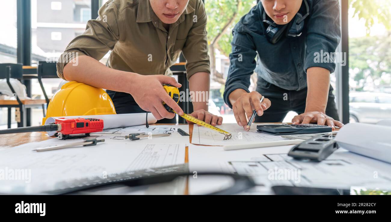 engineer working in office with blueprints, inspection in workplace for ...