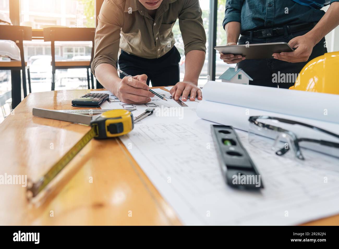 engineer working in office with blueprints, inspection in workplace for ...