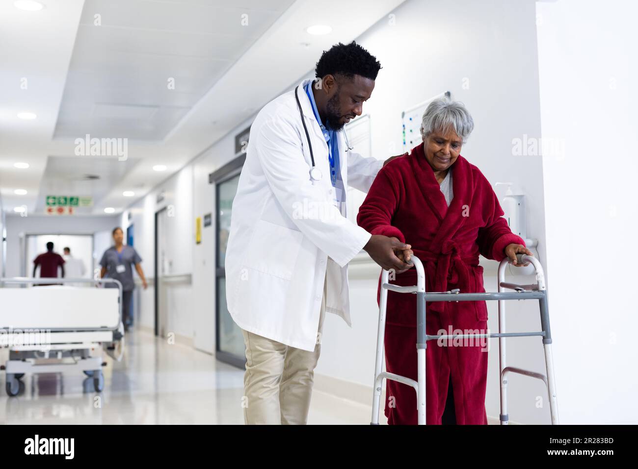 Diverse male doctor helping senior hi-res stock photography and images ...