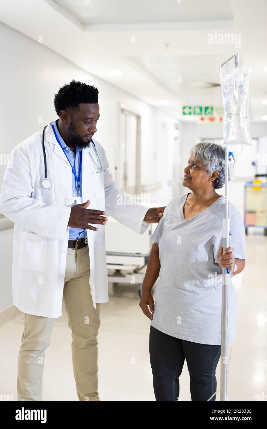 African american male doctor talking to diverse senior female patient ...