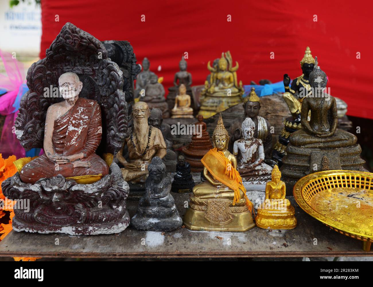 Small Buddha statues at a small temple by an old tree on Koh Kret ...