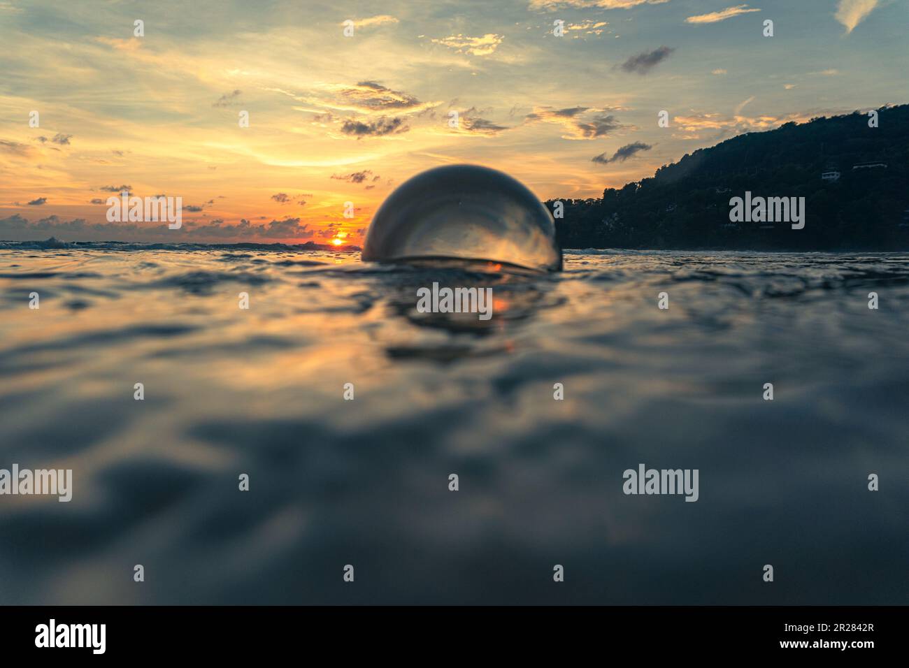 amazing view of beautiful sky at sunset inside crystal ball. colorful ...
