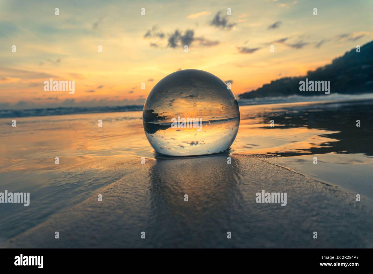 Magnificent sky above the crystal ball on the beach. The beautiful ...