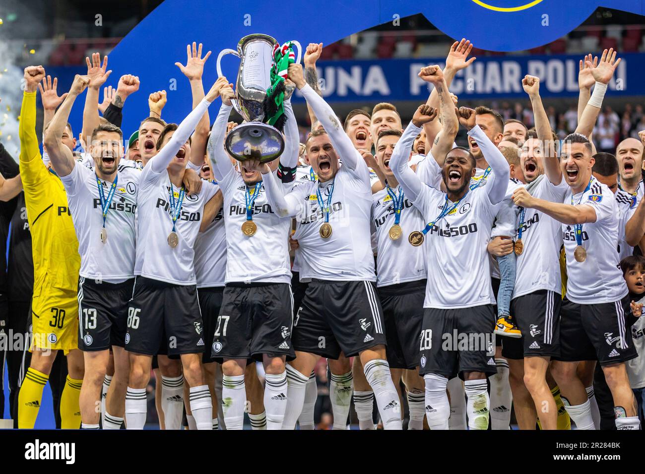 The team of Legia Warszawa celebrate a winning match with a trophy ...
