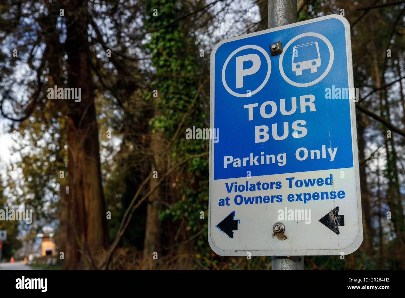 View of a "Tour Bus Parking Only" sign in Stanley Park. The sign is ...